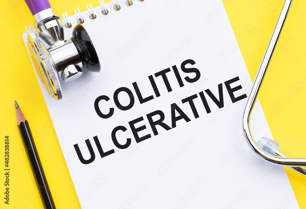 Ulcerative colitis text in white notepad lying on yellow background ...