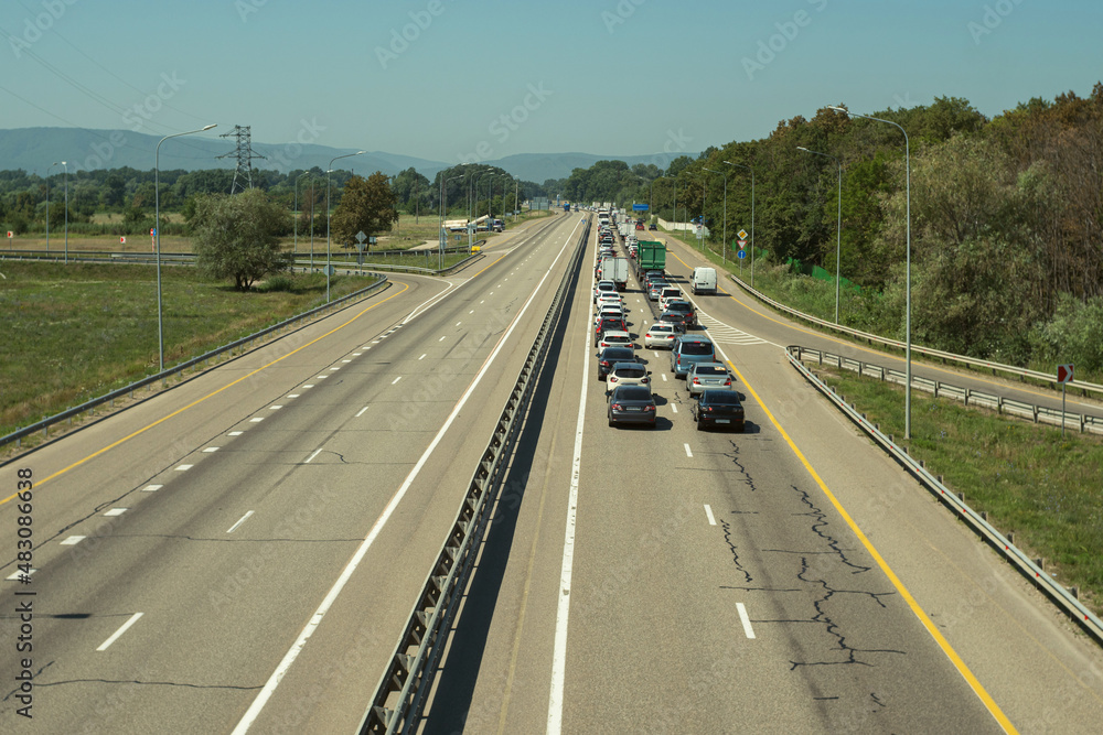 One-way traffic jam on the expressway. Traffic jam on the highway. Blue ...