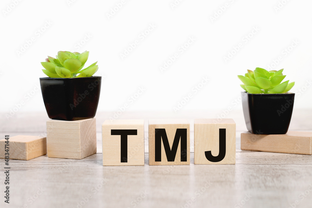 TMJ - acronym from wooden blocks with letters, abbreviation TMJ ...