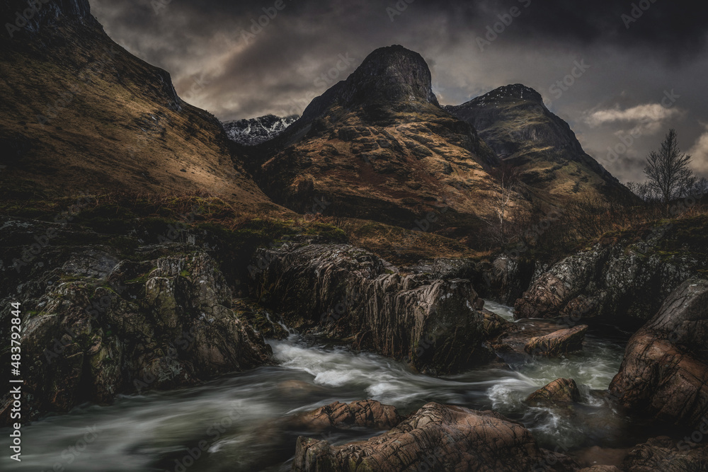 Glencoe Scotland, the three sisters and waterfalls. Dramatic stormy sky ...