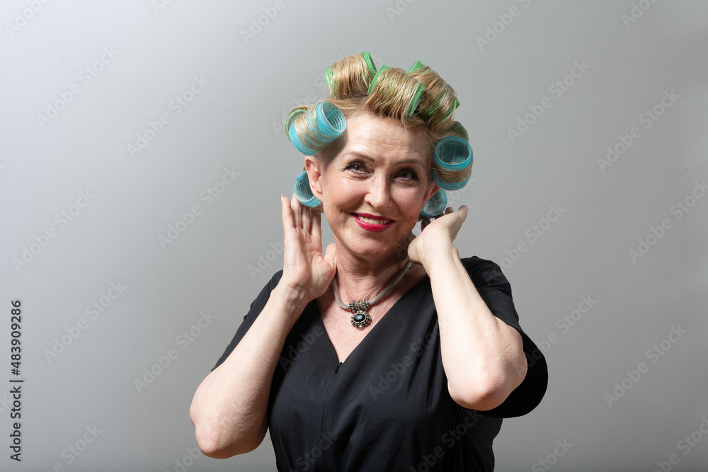 Elderly old granny aged woman smiling housewife with curlers rollers on ...