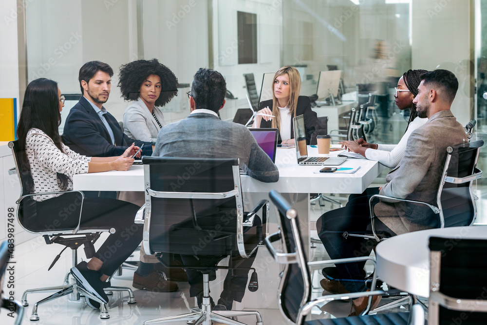 Business people discussing together in conference room during meeting ...