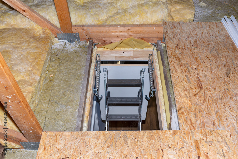 Sliding metal stairs to the attic in the ceiling, open flap and ...