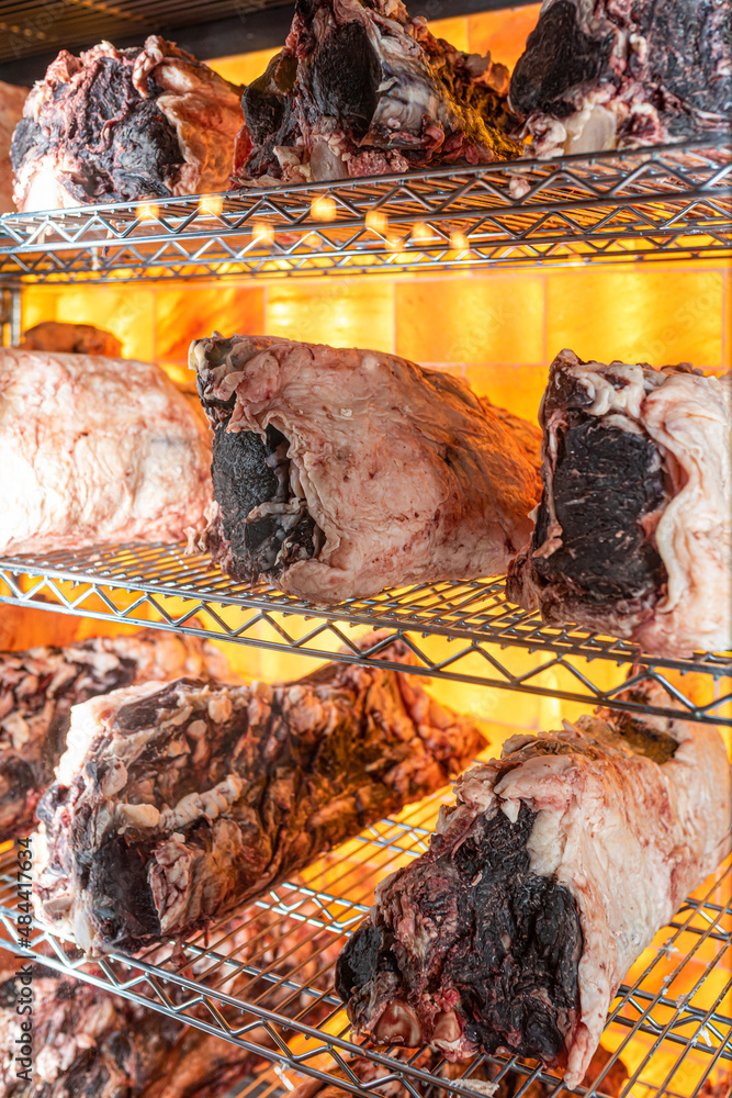 Beef hung and lined up in a dry aged beef cabinet Stock Photo | Adobe Stock