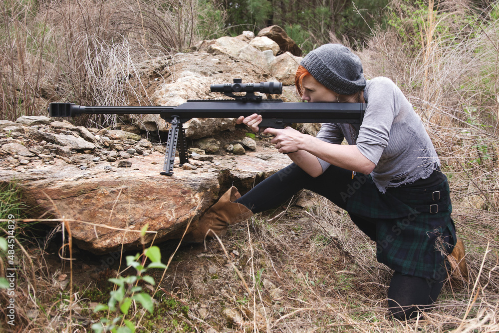 Beautiful and intense redhead sniper woman with short hair and stocking ...
