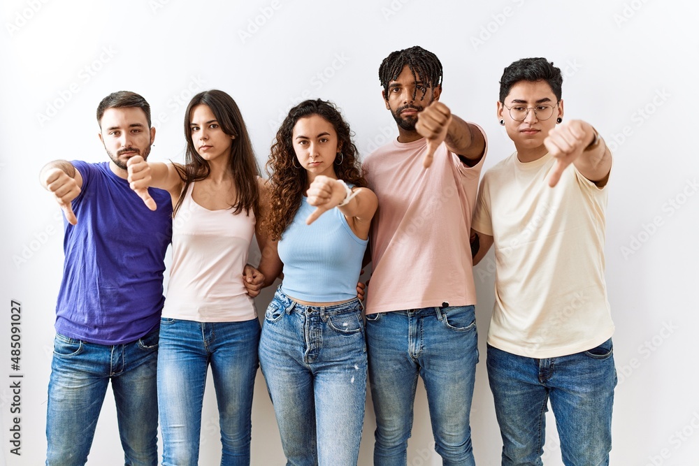Group of young people standing together over isolated background ...