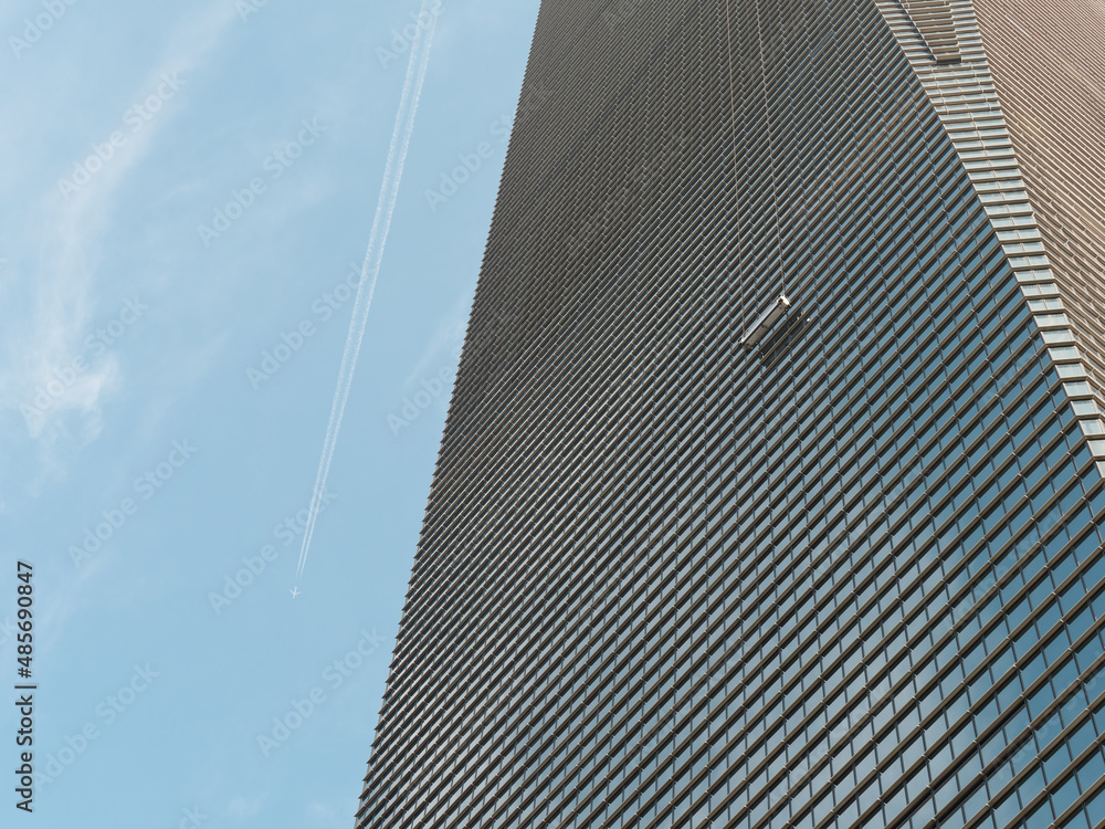 Low angle side view of window clean platform against the facade of a ...