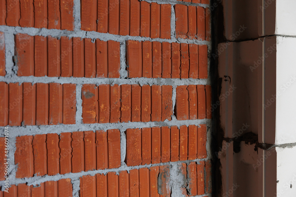 Brickwork of red lightweight clay bricks. Construction of the wall with ...