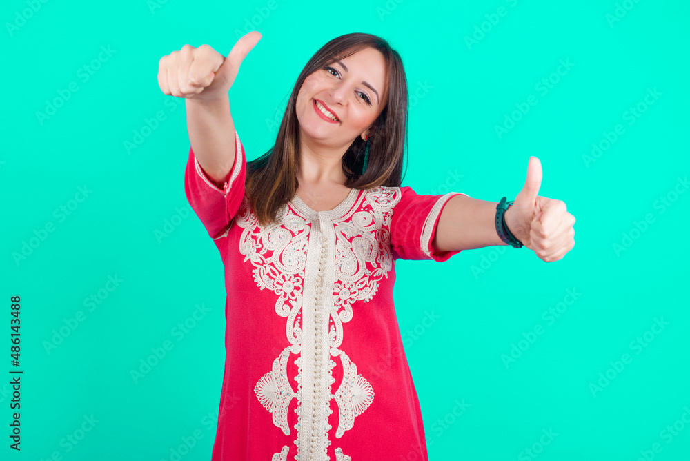 young beautiful moroccan woman wearing traditional caftan dress over ...