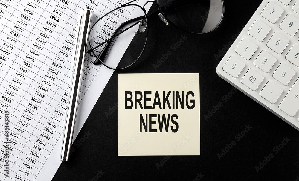 Concept BREAKING NEWS message on sticker with glasses,chart and ...