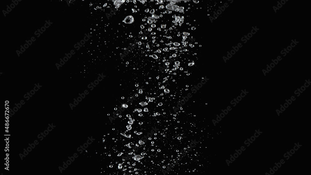 Soda water bubbles splashing and floating drop in black background represent sparkling and ...