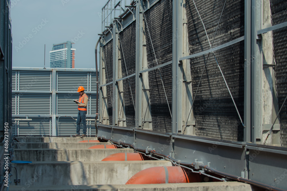 Engineer under checking the industry cooling tower air conditioner is ...