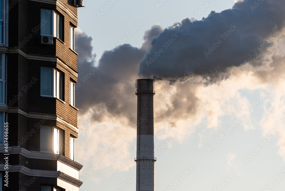 Pipe of combined heat and power plant CHP against background of multi ...