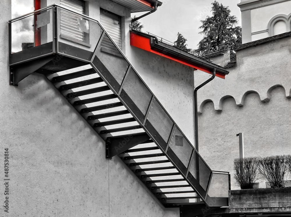 Staircase iron with stainless rail is connected to the building. Use a ...