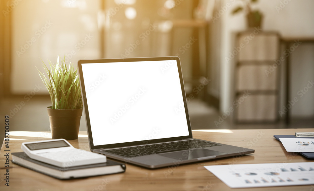 Mockup laptop computer with white screen put on desk table of business ...
