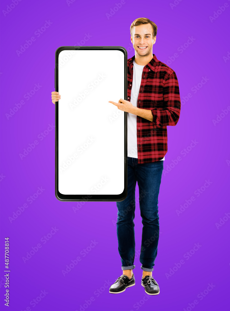 Mobile app advertisement concept. Happy smiling young man pointing ...