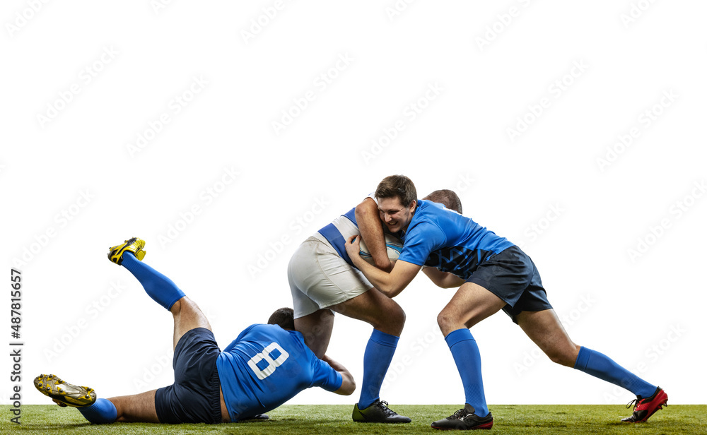 Dynamic portrait of male rugby players playing rugby football on grass ...