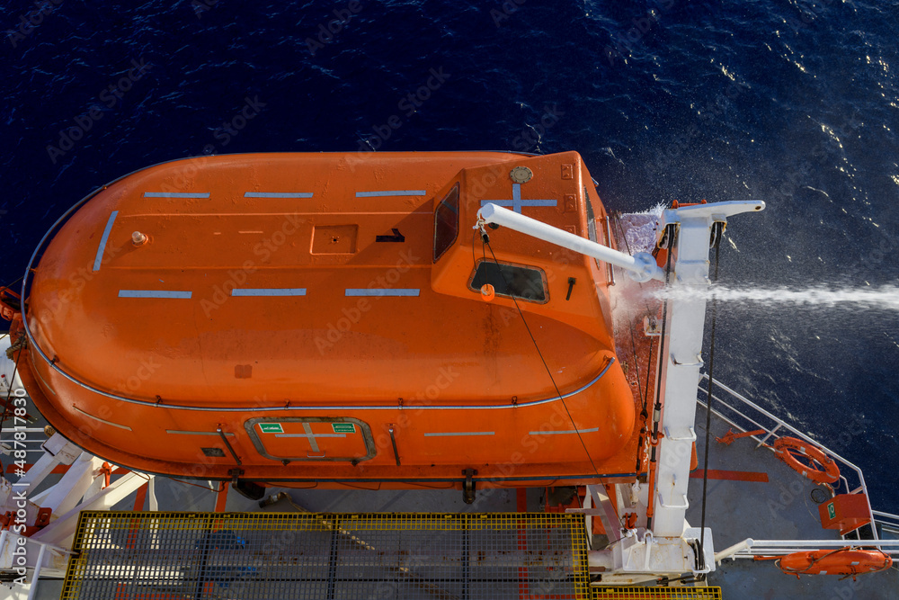 Hose pressure water test of totally enclosed lifeboat. Watertight test ...