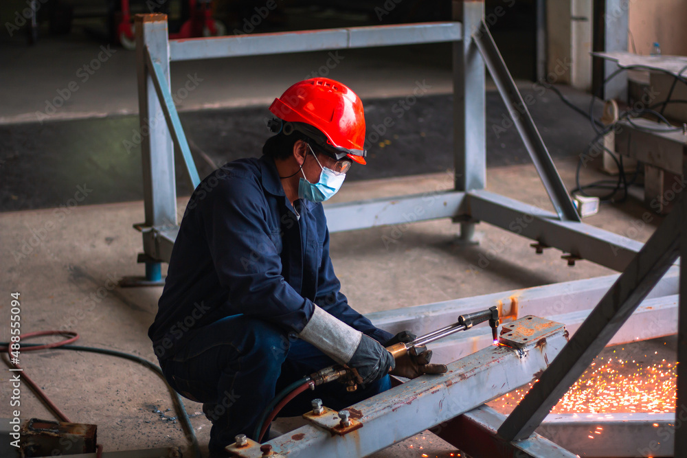 Welder is welding the steel in the factory. Weld the steel in dark ...