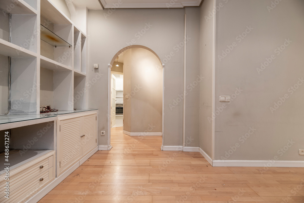 living room with plaster and wood furniture built into the wall with ...