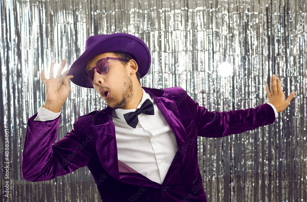 Portrait of stylish and cool young showman, cheerful partygoer or ...