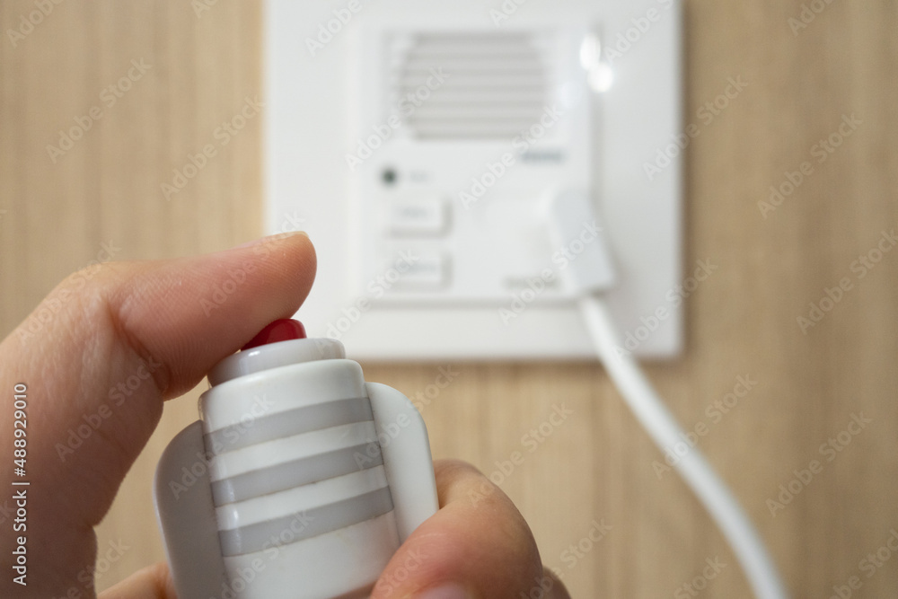 Patient holding nurse call bell button for communicate with doctor ...