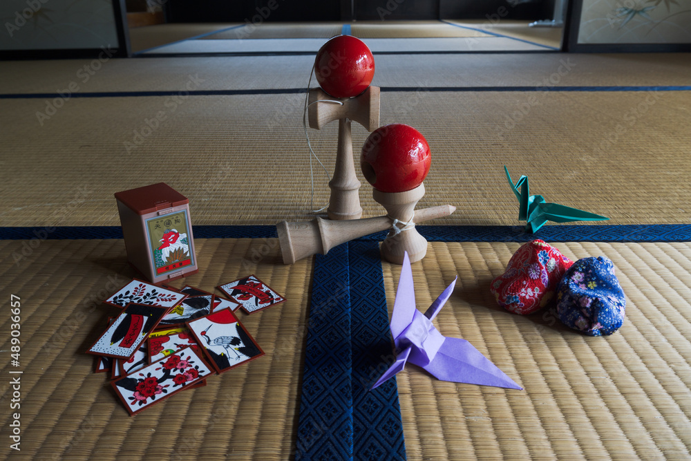 Traditional Japanese games: Kendama, Origami and Menko, displayed on a ...