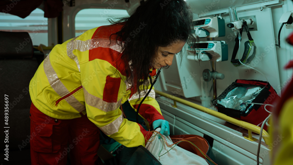 Young Ethnic Female Paramedic Helping Out a Patient In the Ambulance ...