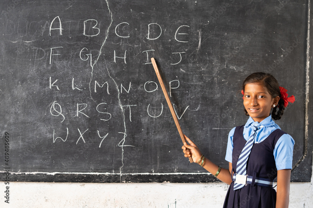 girl kid from blackboard at public school teaching alphabets to ...
