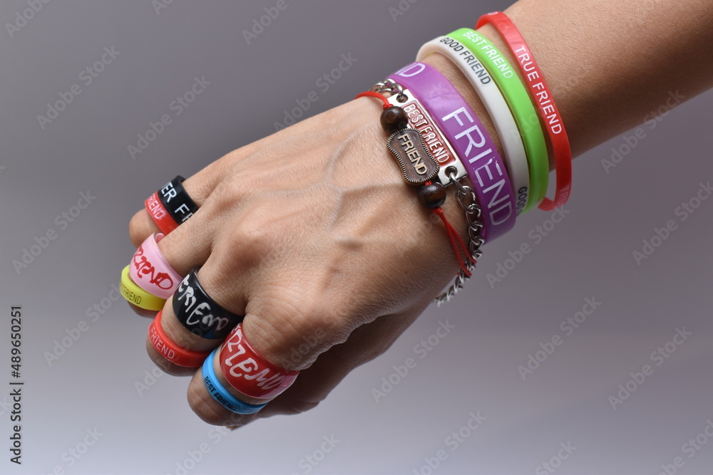 Hand wrist with friendship bands and friendship rings on the occasion ...