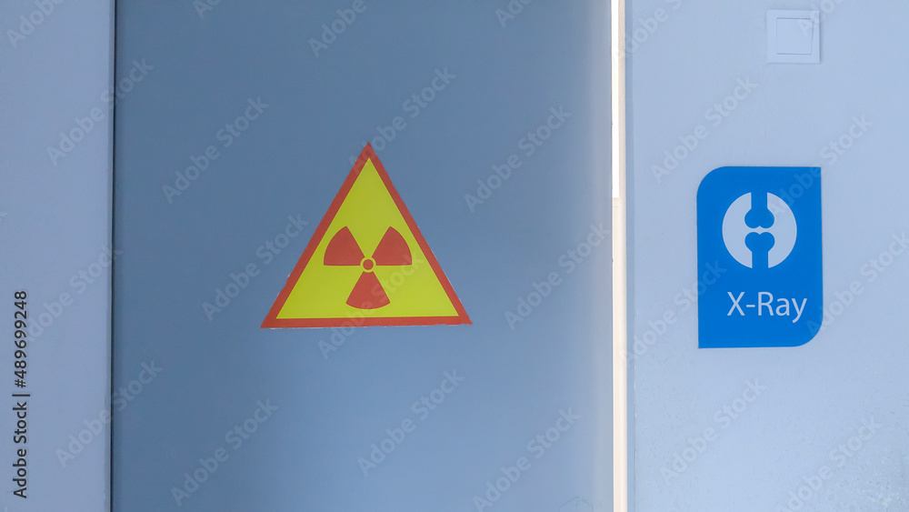 Xray warning signs posted on locked door and wall. Radioactive sign in ...