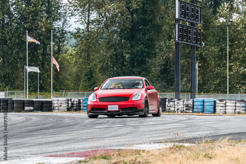 Stock-Foto „Red Drift Car / Race car drifting around corner very fast ...