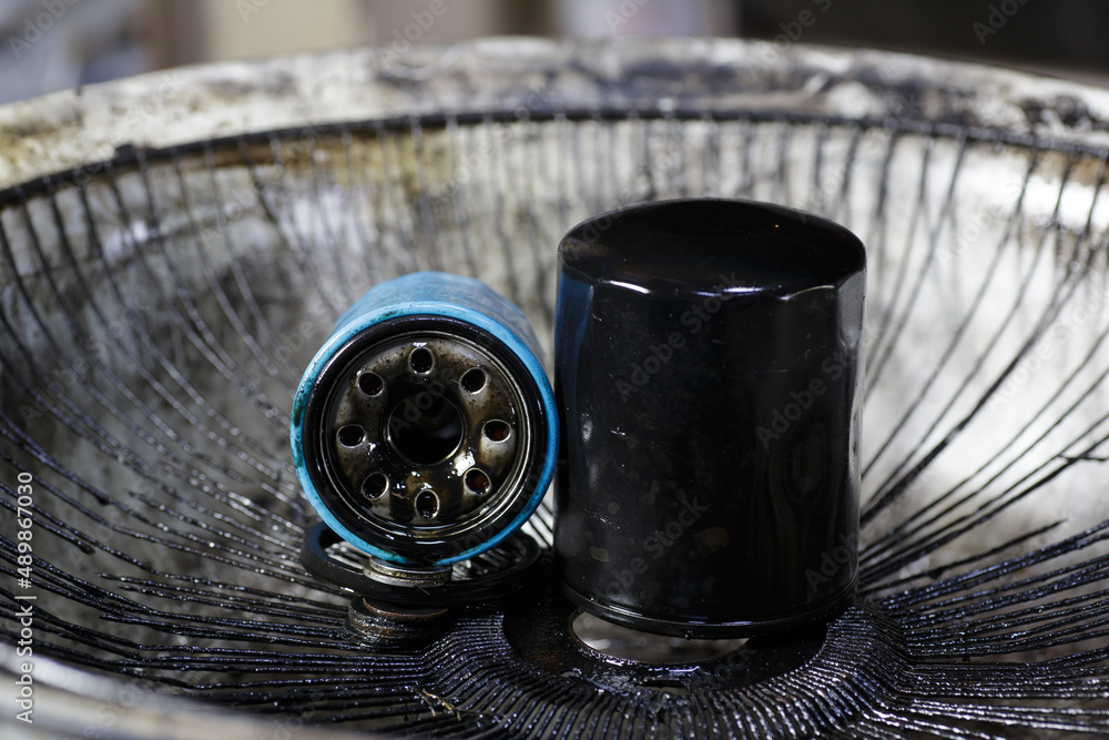Car oil filter is very dirty and oil stains background.engine oil stain ...