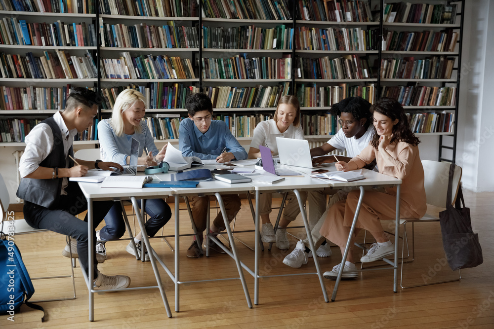 Full length concentrated team of multiethnic millennial college ...