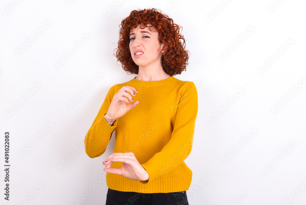 Ugh how disgusting! Displeased young redhead girl wearing yellow ...