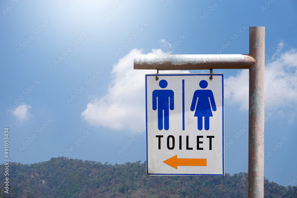 TOILET sign with male ,female and arrow symbols to show the way to ...