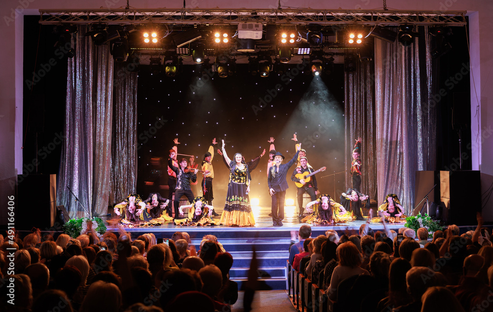 A collective of musicians, singers and dancers in gypsy costumes ...