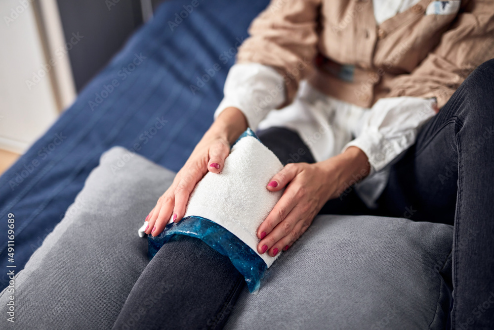 Woman with spasm, cramp, sprained, dislocated knee, ruptured tendon and ...