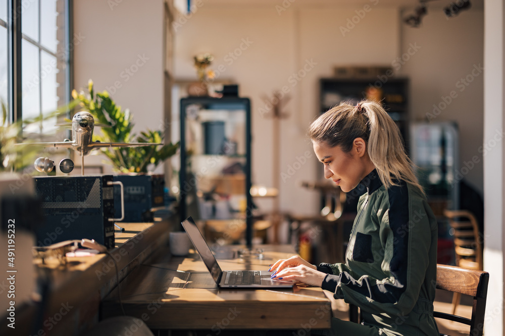 Side profile of a girl in a pilot uniform, using a laptop. Stock Photo ...