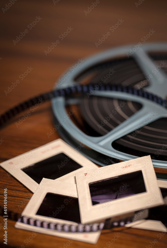 Shallow focus background image of 35mm slides and 8mm Super 8 film reel ...