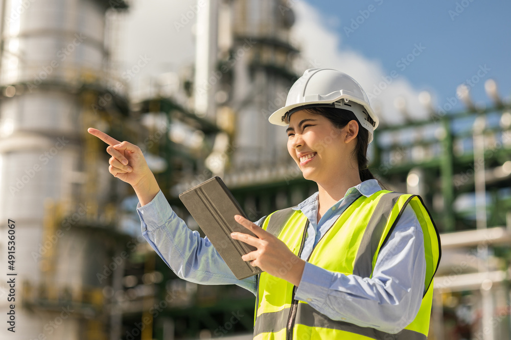 Asian engineer manager woman with white safety helmet standing front of ...