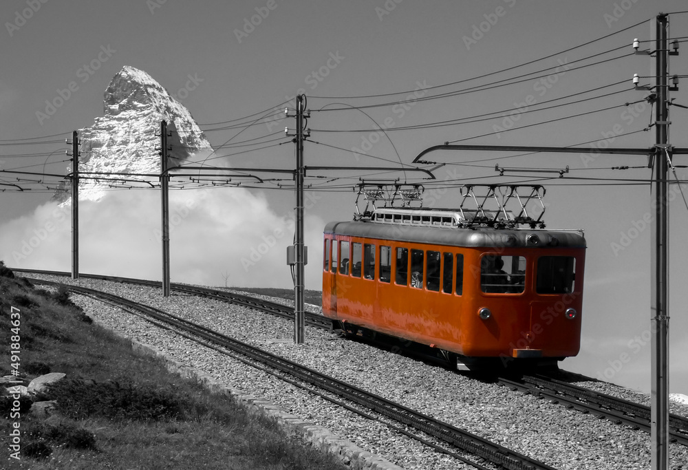 Famous narrow gauge gear train “Gornergrat-Bahn“ climbing up to ...
