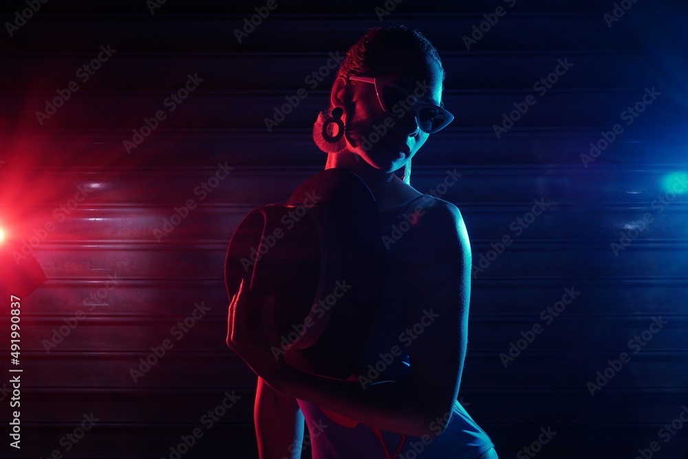 Fashion art photo of elegant model in the light colored spotlights ...