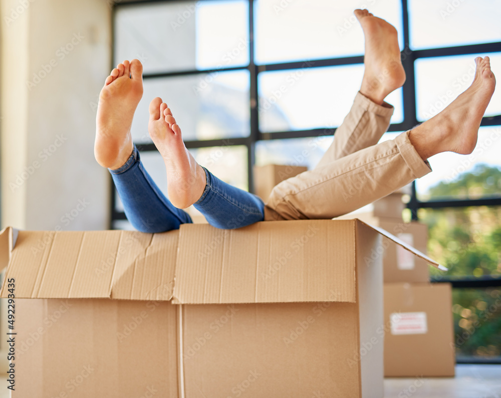 Handle with care. Shot of an unidentifiable young couple lying in a box ...