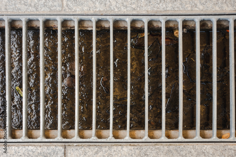 Steel grating on trapped drainage gutter Stock Photo | Adobe Stock