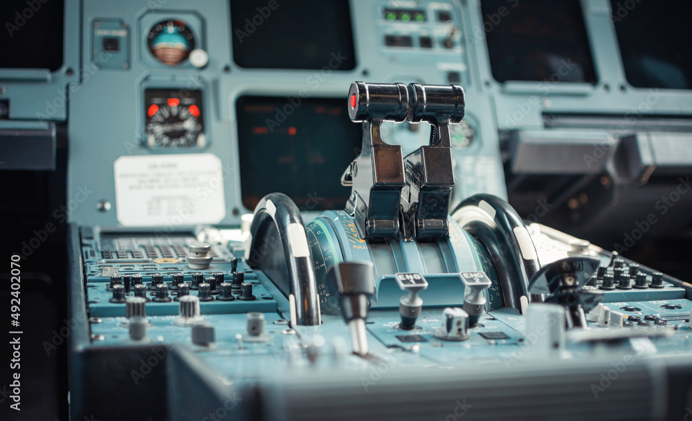 Thrust levers in cockpit of modern aircraft. Depth of field shot of ...
