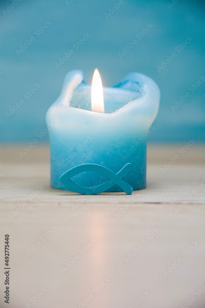 Candle with fish as a symbol for confirmation, communion, baptism ...