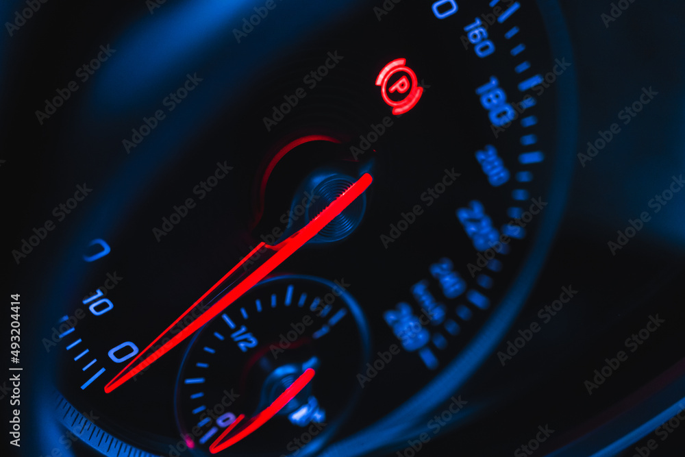 Glowing car speedometer close-up view background. Luxury dashboard with ...