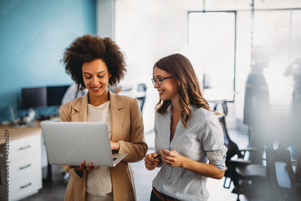 Happy multiethnic smiling business women working together in office Stock Photo | Adobe Stock