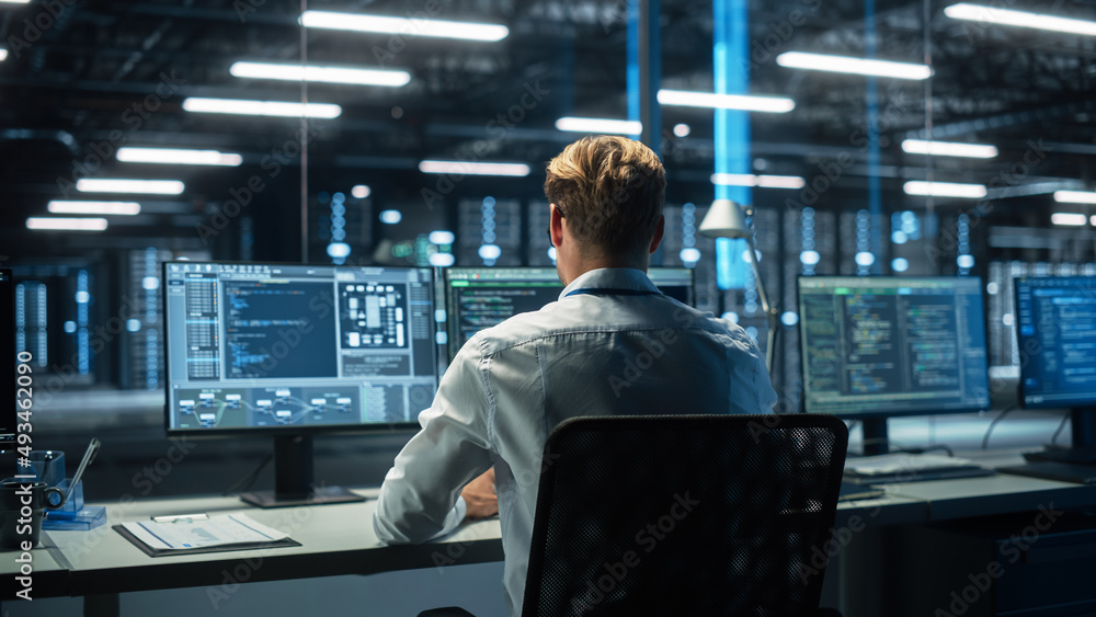 Foto Operator Sitting and Monitoring Various Activities Showing on Multiple Displays with ...